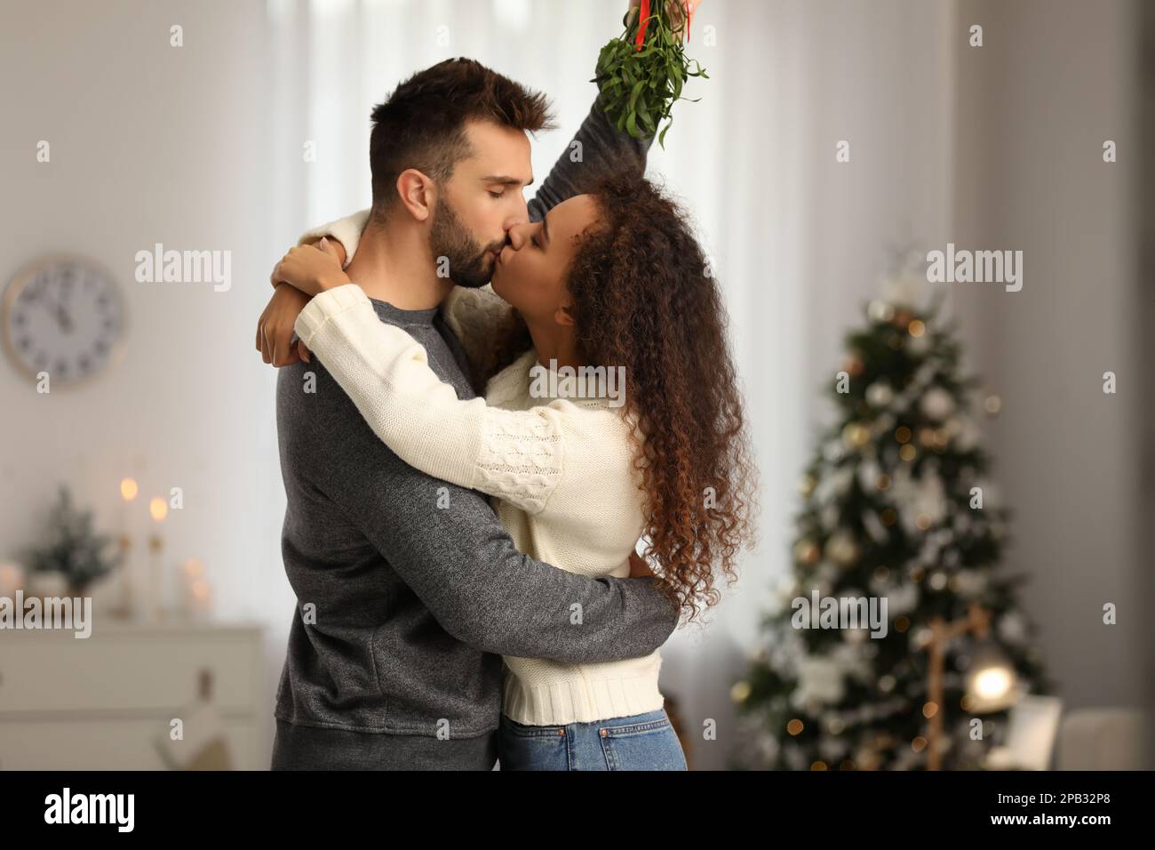 Kissing under the mistletoe portrait hi-res stock photography and ...