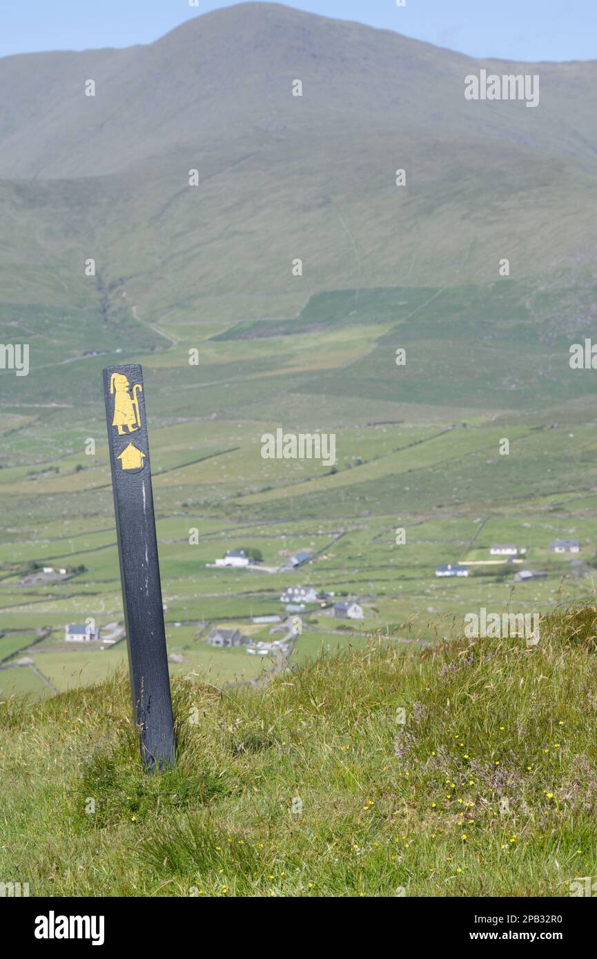 Marker sign for Pilgrim's Way or Pilgrim's path with mountain behind ...