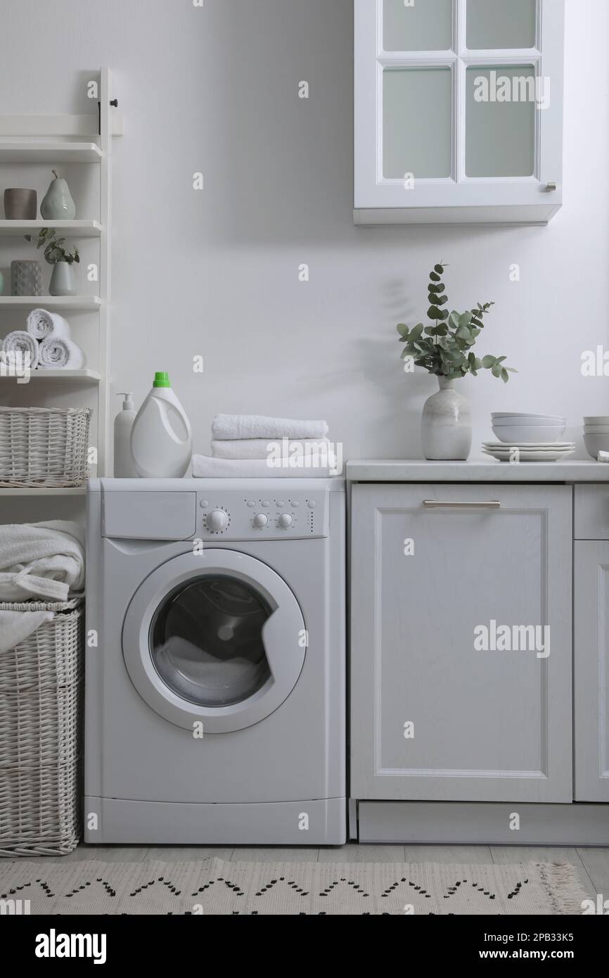 Kitchen interior with washing machine and stylish furniture Stock Photo ...