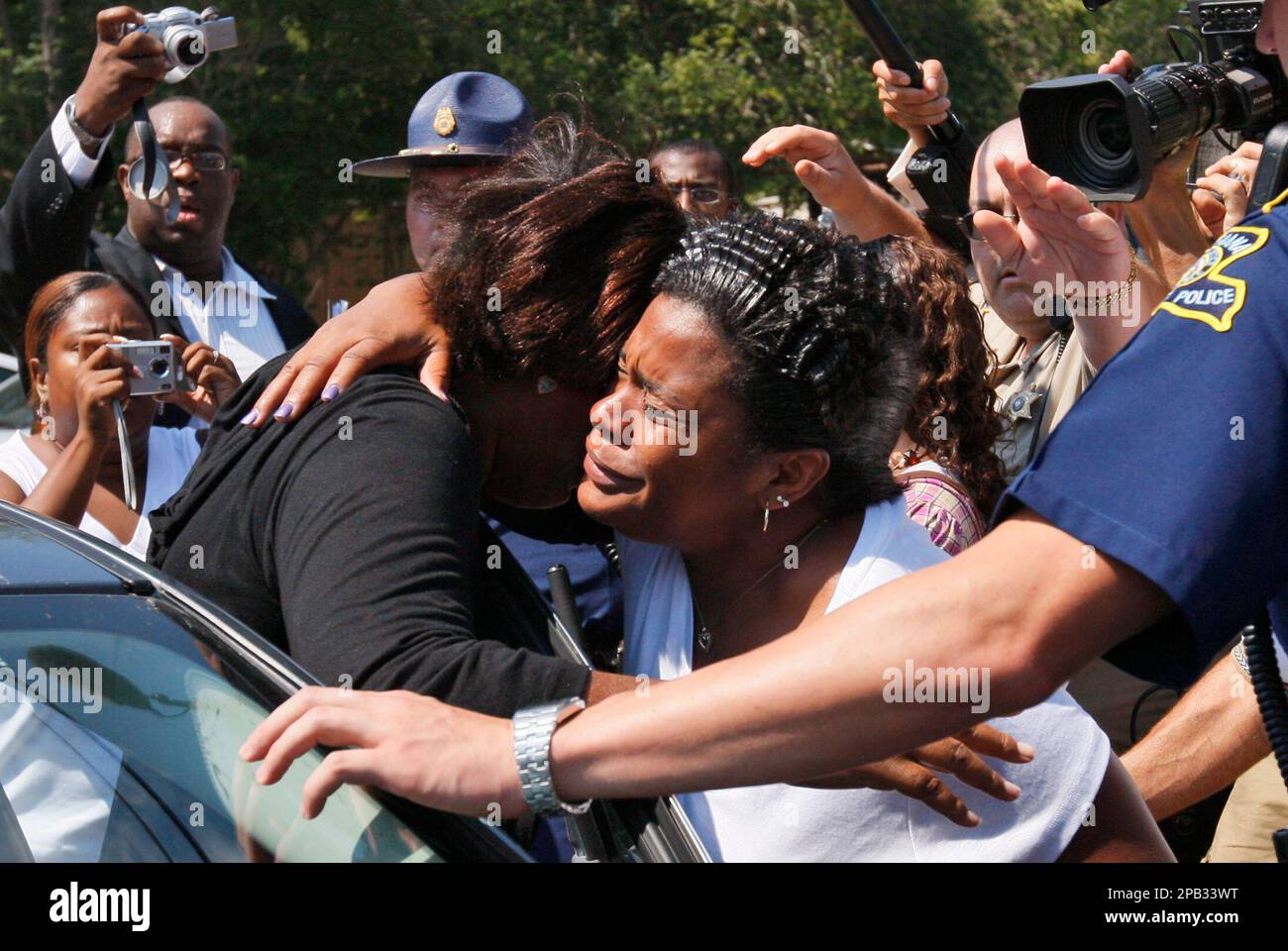 Melissa Bell, mother of Mychal Bell, right, cries and hugs her sister ...