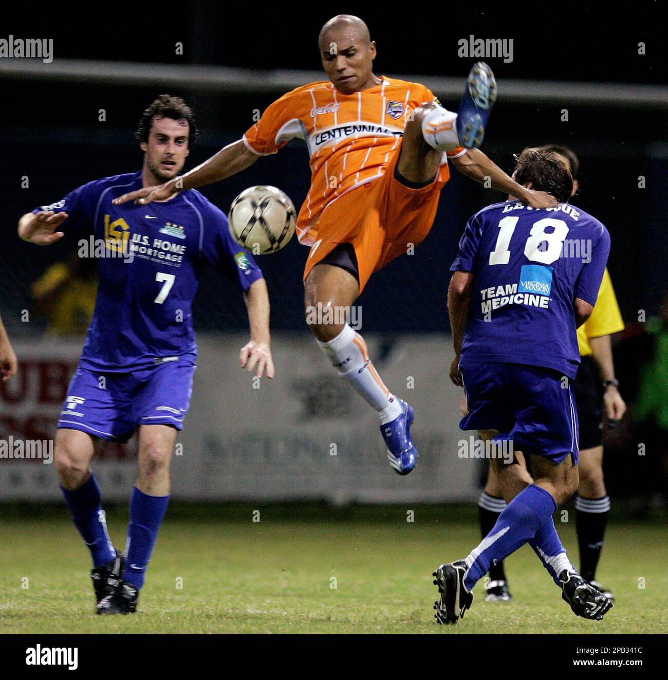 Puerto Rico Islanders' Edwin Miranda, center, tries to control the ball ...