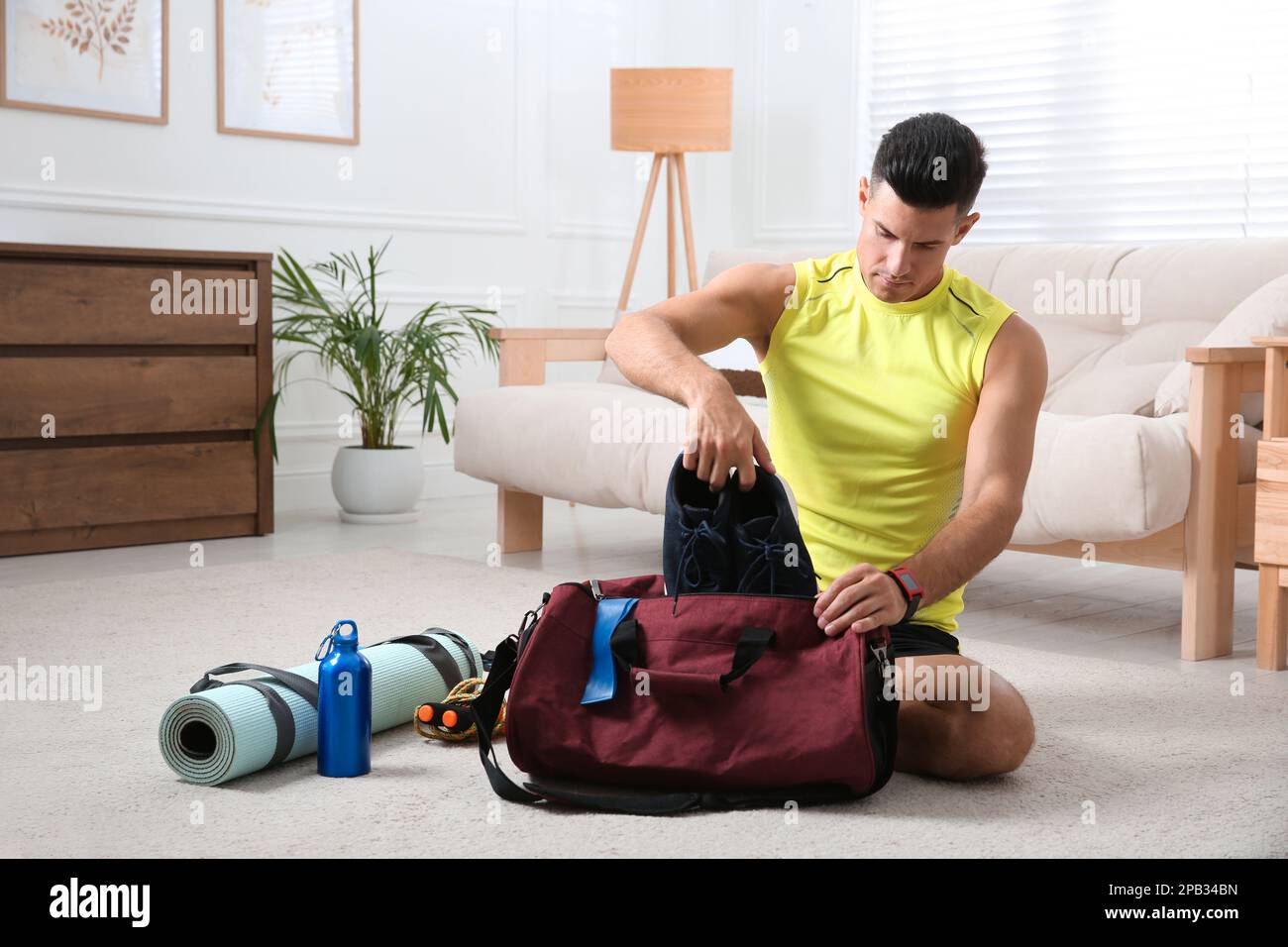 Athletic man packing gym bag hi-res stock photography and images - Alamy