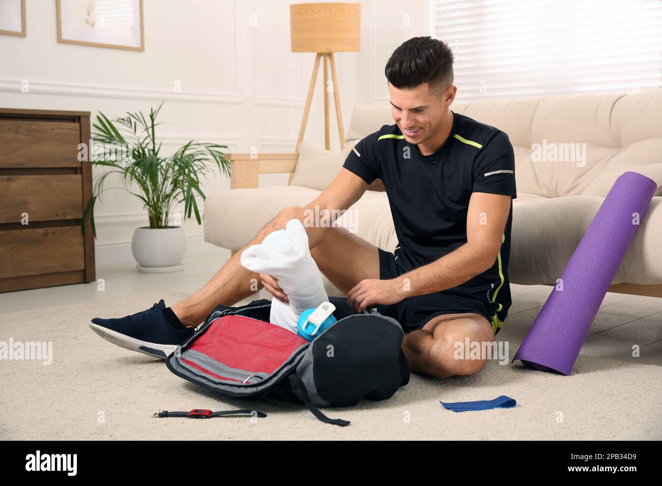 Athletic man packing gym bag hi-res stock photography and images - Alamy