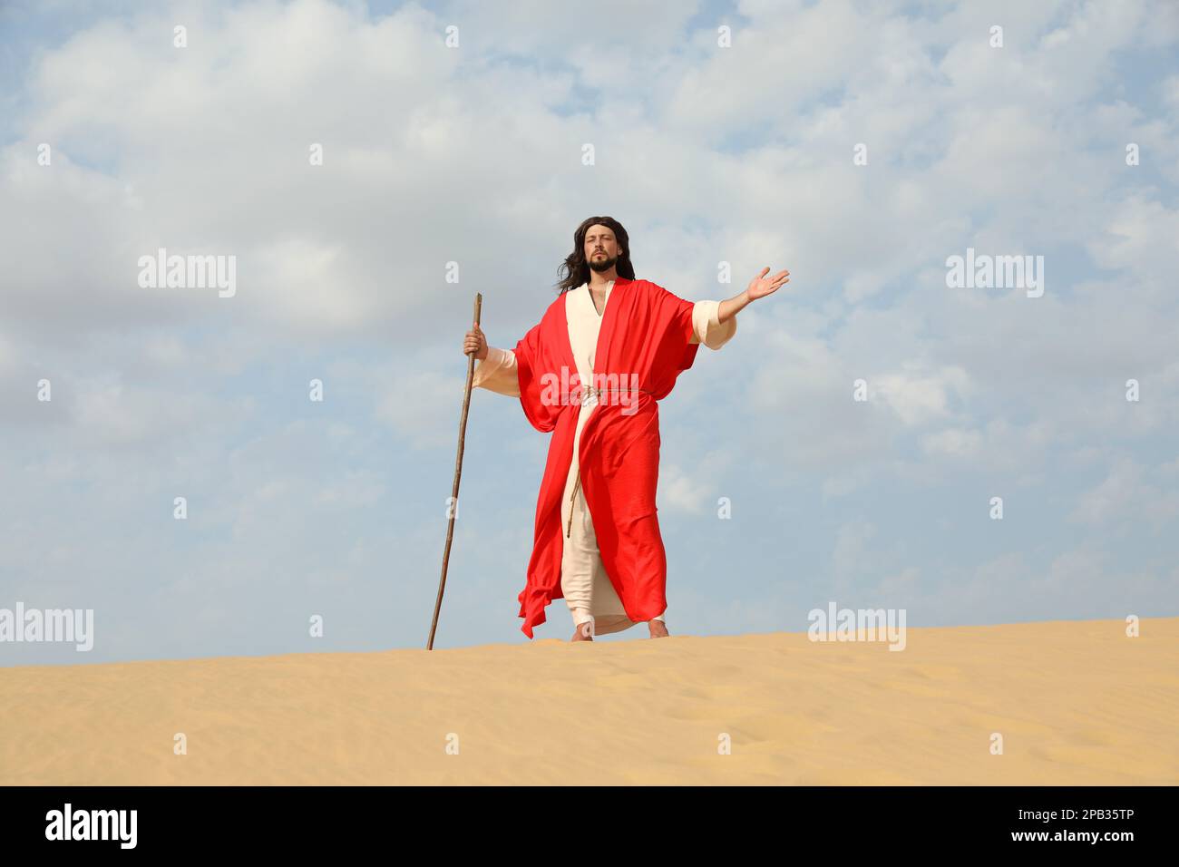 Jesus Christ walking with stick in desert Stock Photo - Alamy