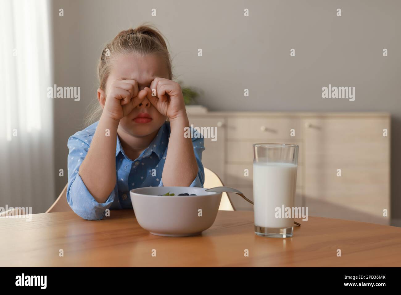 Cute little girl crying and refusing to eat breakfast at home Stock ...