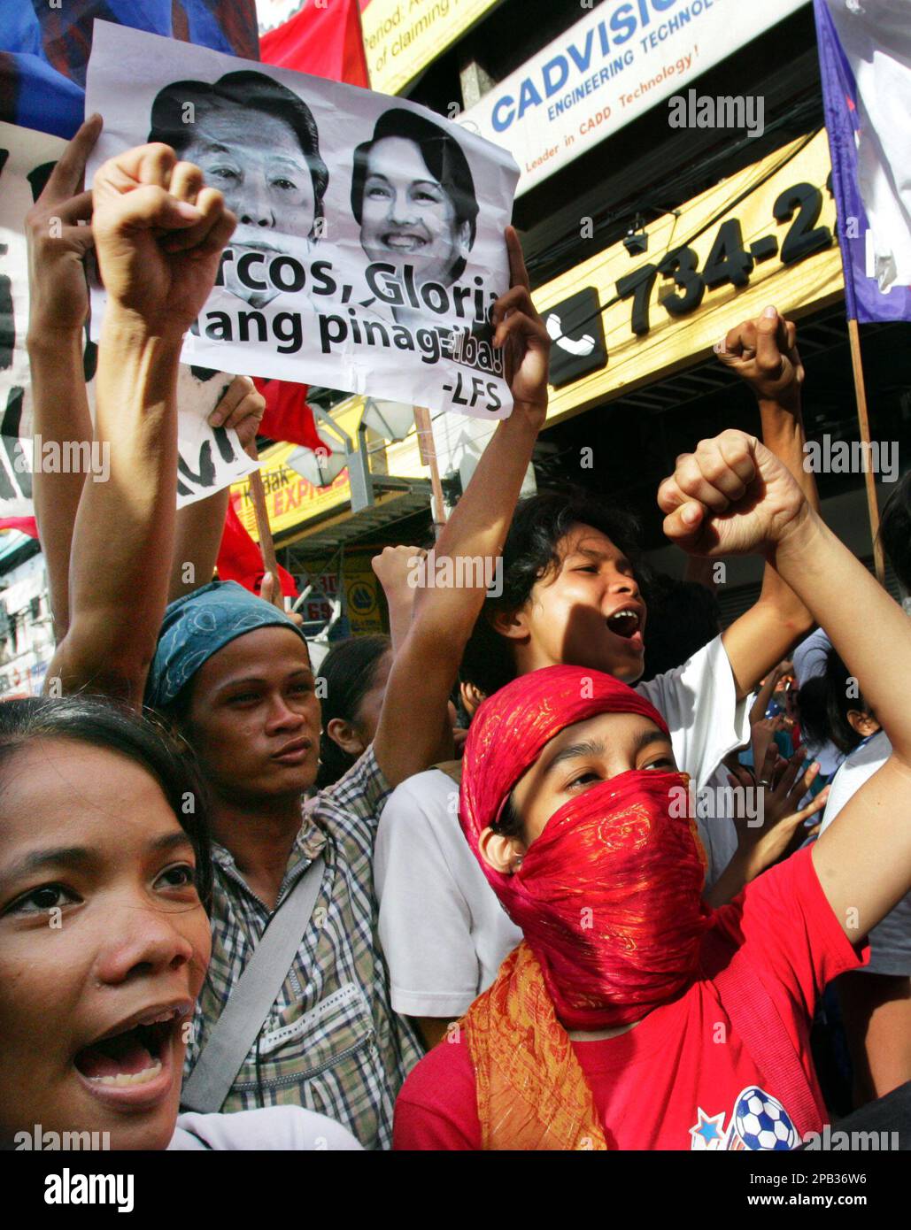 Protesters shout slogans as they display a picture of the late ...