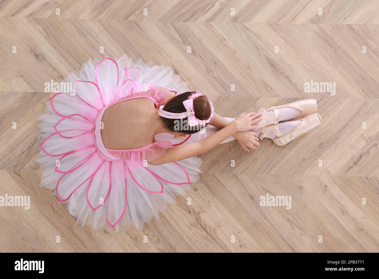Beautifully dressed little ballerina on floor in studio, top view Stock ...