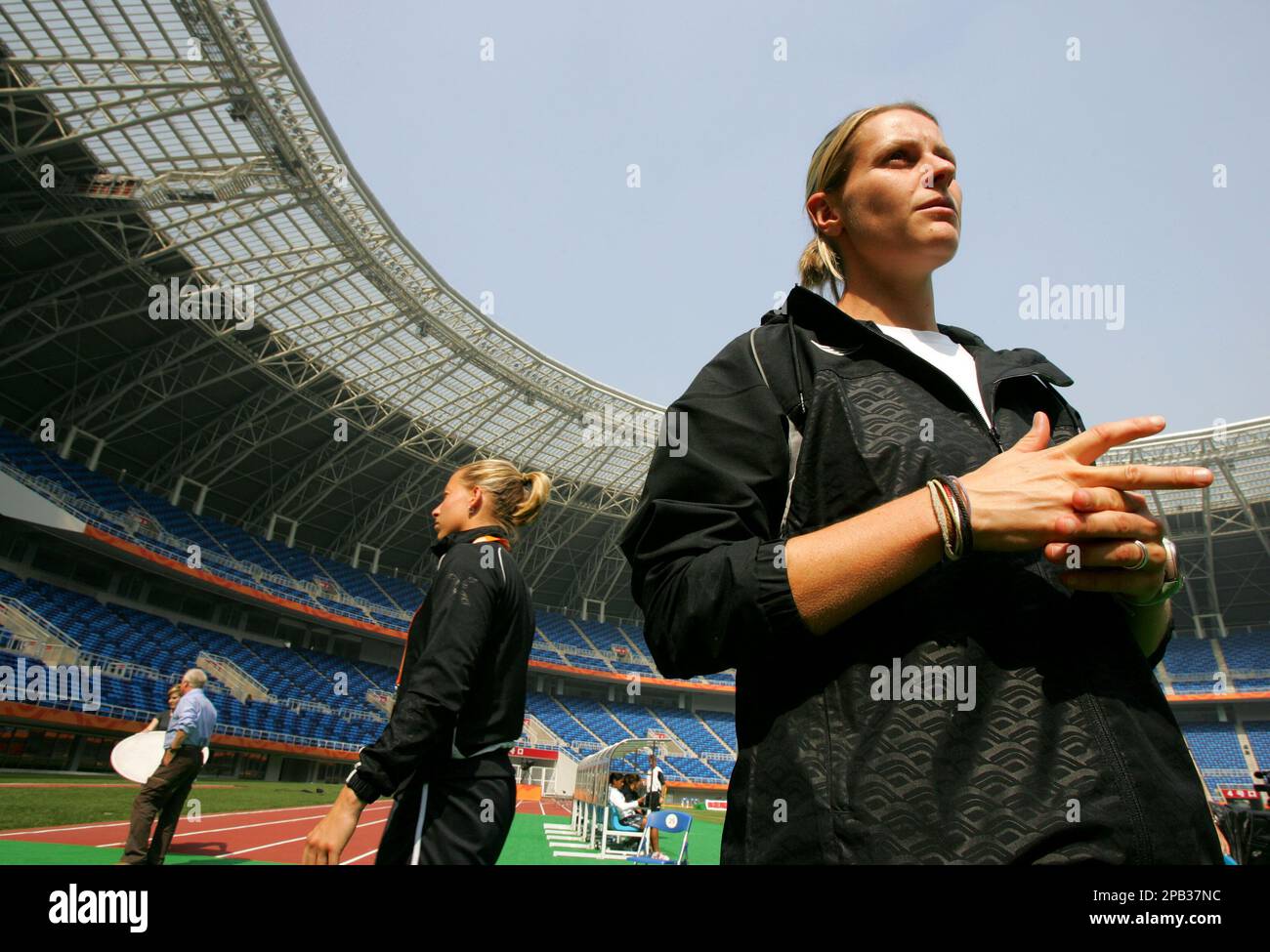 Kelly Smith, right, and Rachel Brown, left, walk through the Tianjin ...