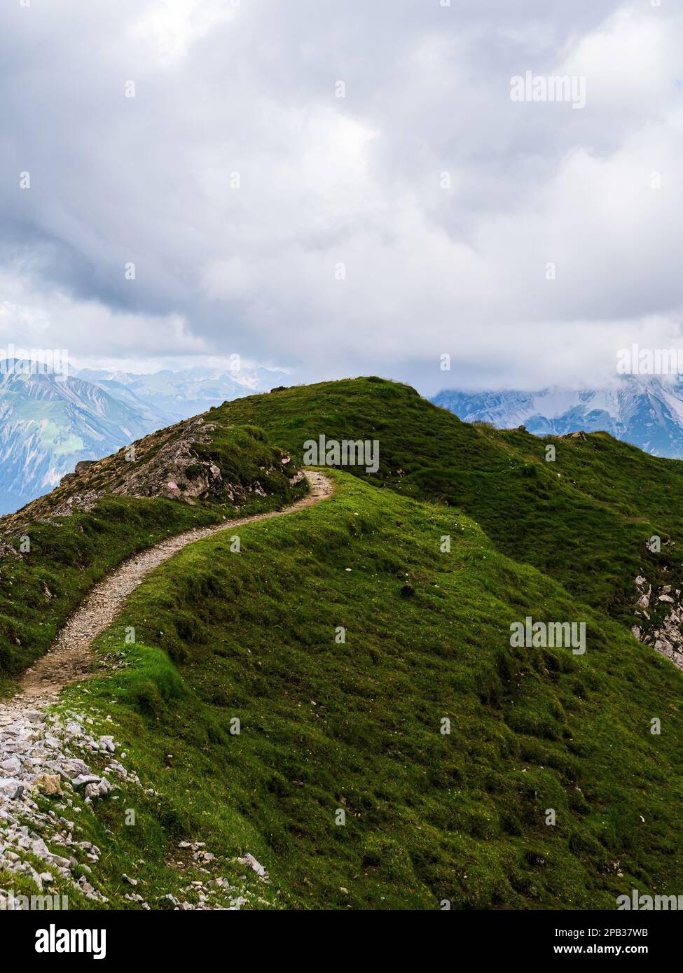 Wavy path on a mountain ridge meadow Stock Photo - Alamy
