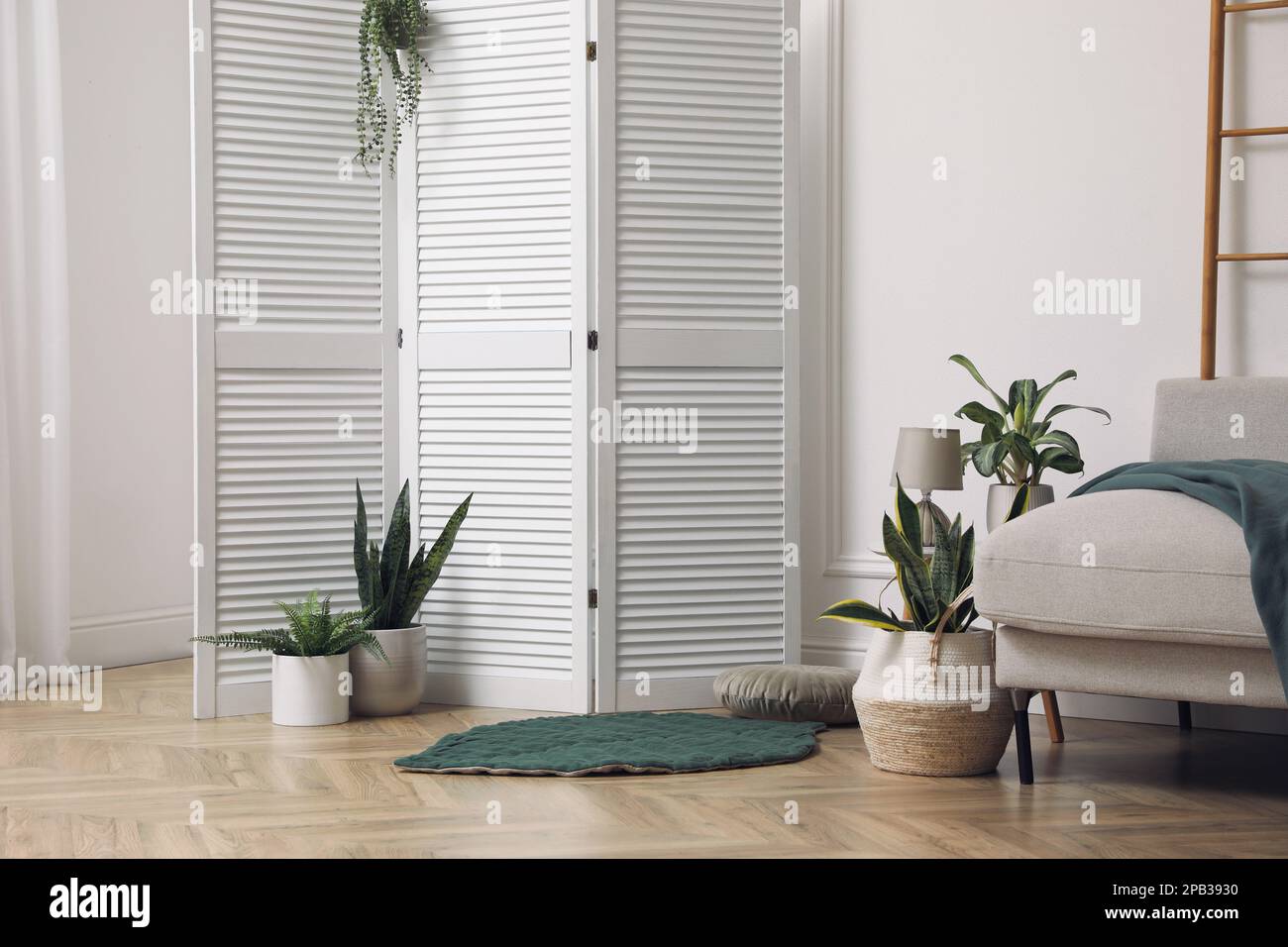 Stylish living room with folding screen and sofa. Interior design Stock ...