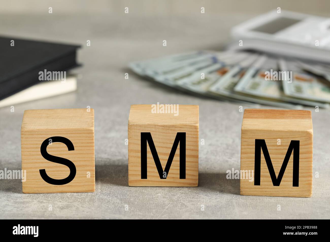 Wooden cubes with letters SMM on grey stone table Stock Photo - Alamy