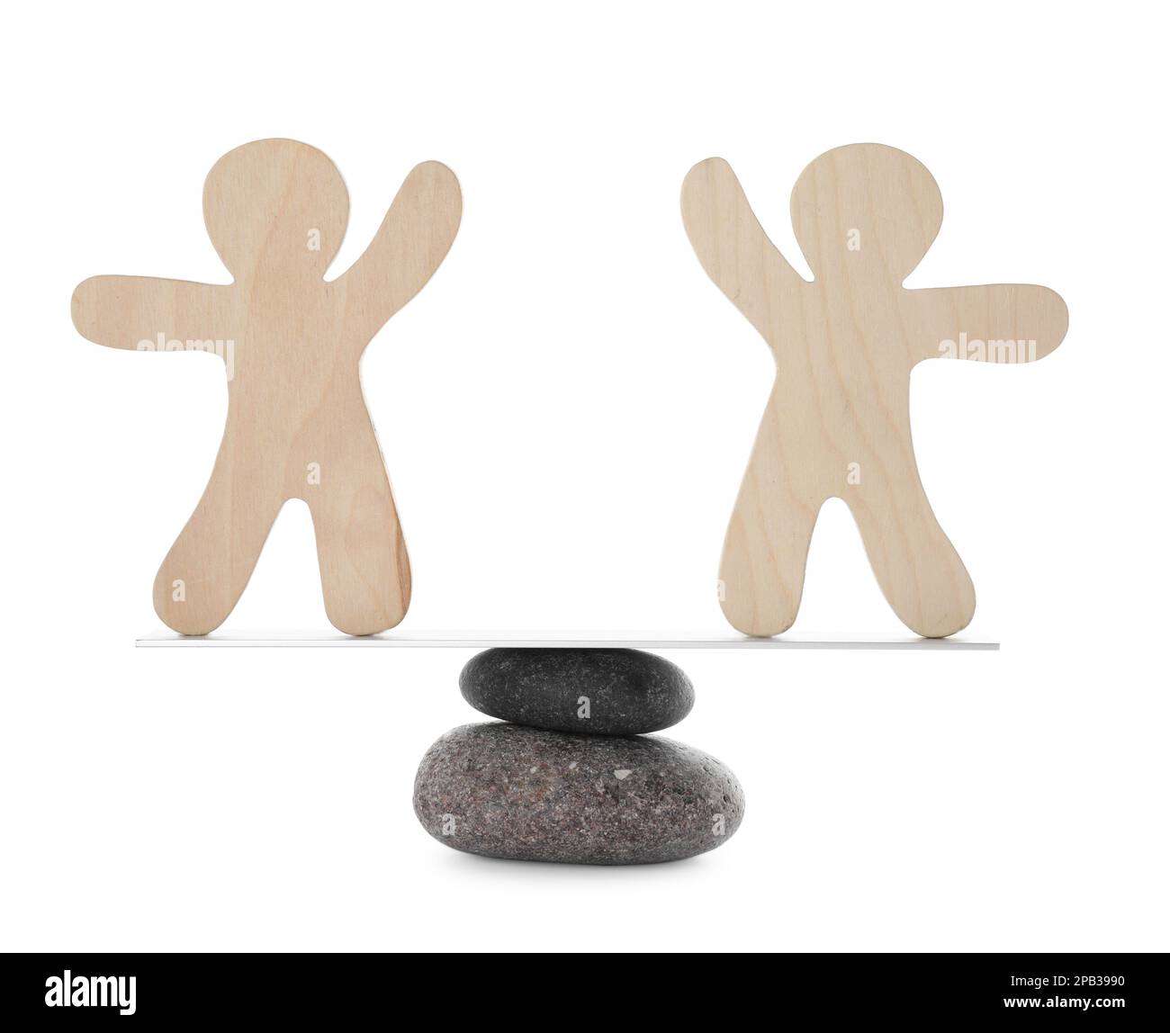 Balancing wooden human figures on stones against white background Stock ...