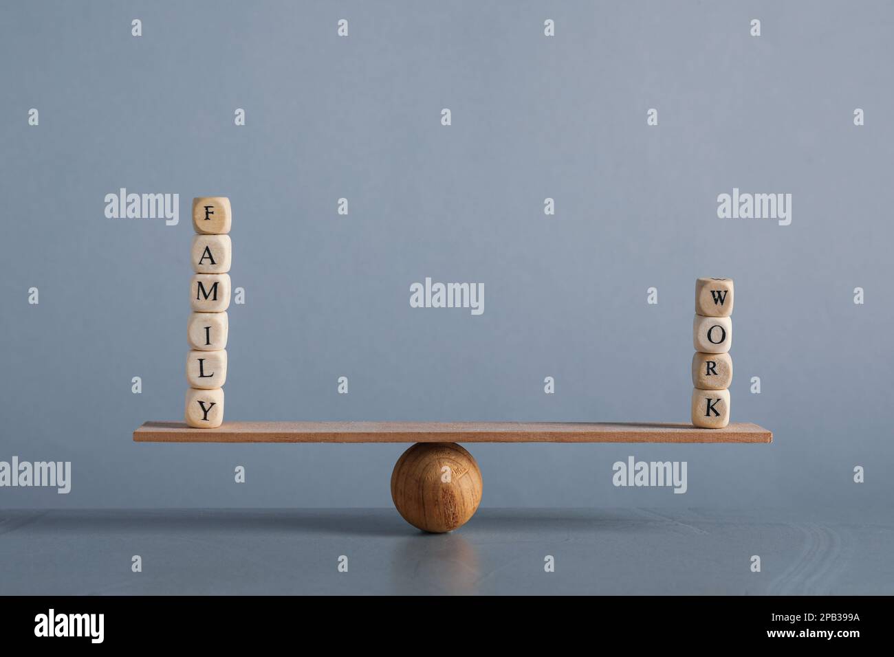 Work family balance concept. Wooden ball with cubes and small plank on ...