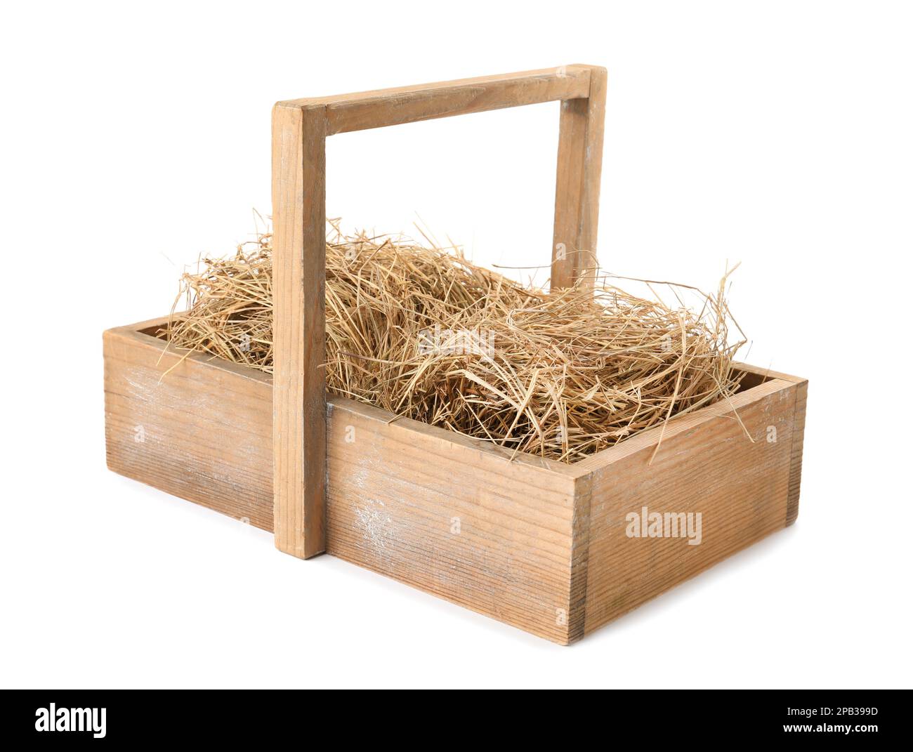 Dried hay in wooden basket on white background Stock Photo - Alamy