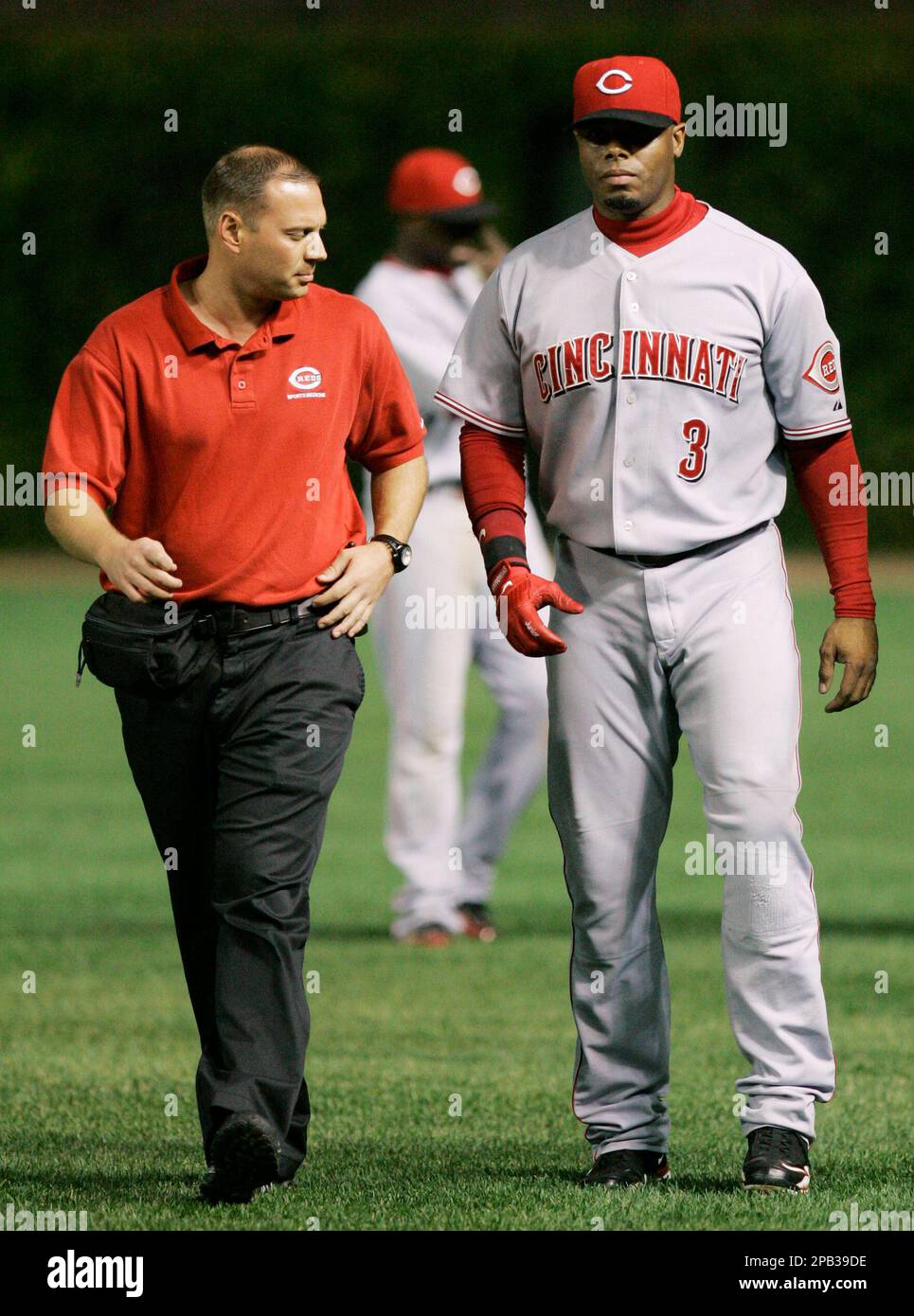Cincinnati Reds' Ken Griffey Jr., right, walks off the field with ...
