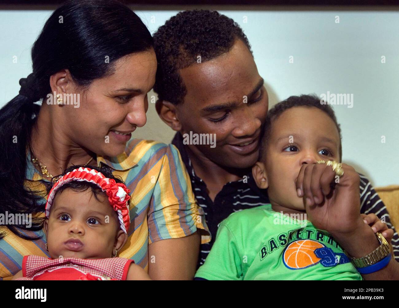 Cuban baseball player Alexei Ramirez, center right, sits with his wife ...
