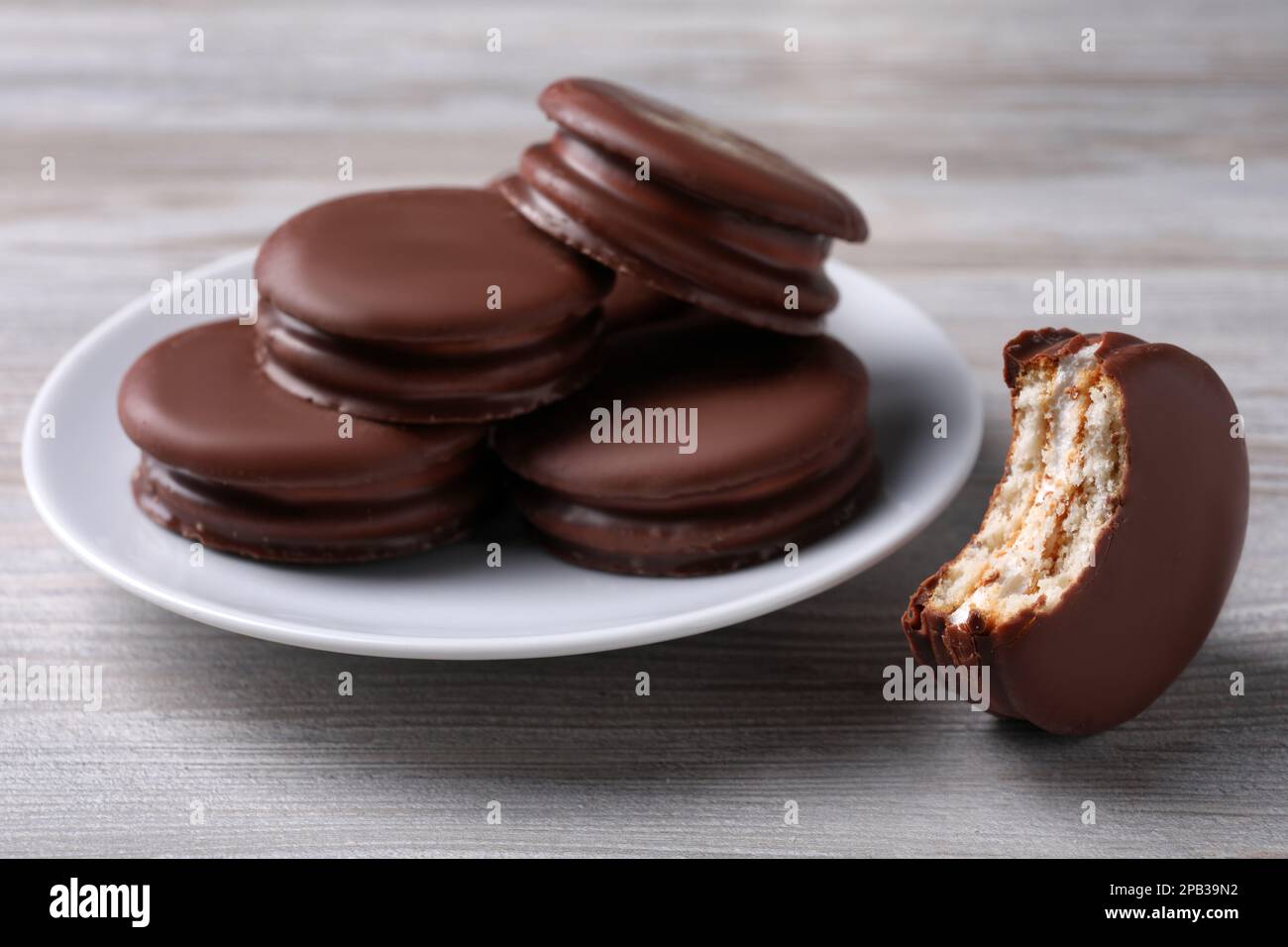 Tasty choco pies on white wooden table Stock Photo - Alamy