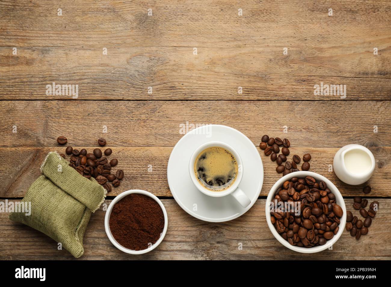 Flat lay composition with coffee grounds and roasted beans on wooden ...