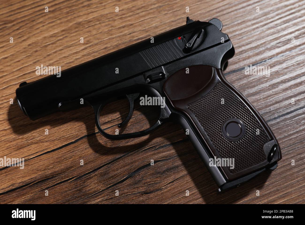 Handgun on wooden table, top view. Semi-automatic pistol Stock Photo ...