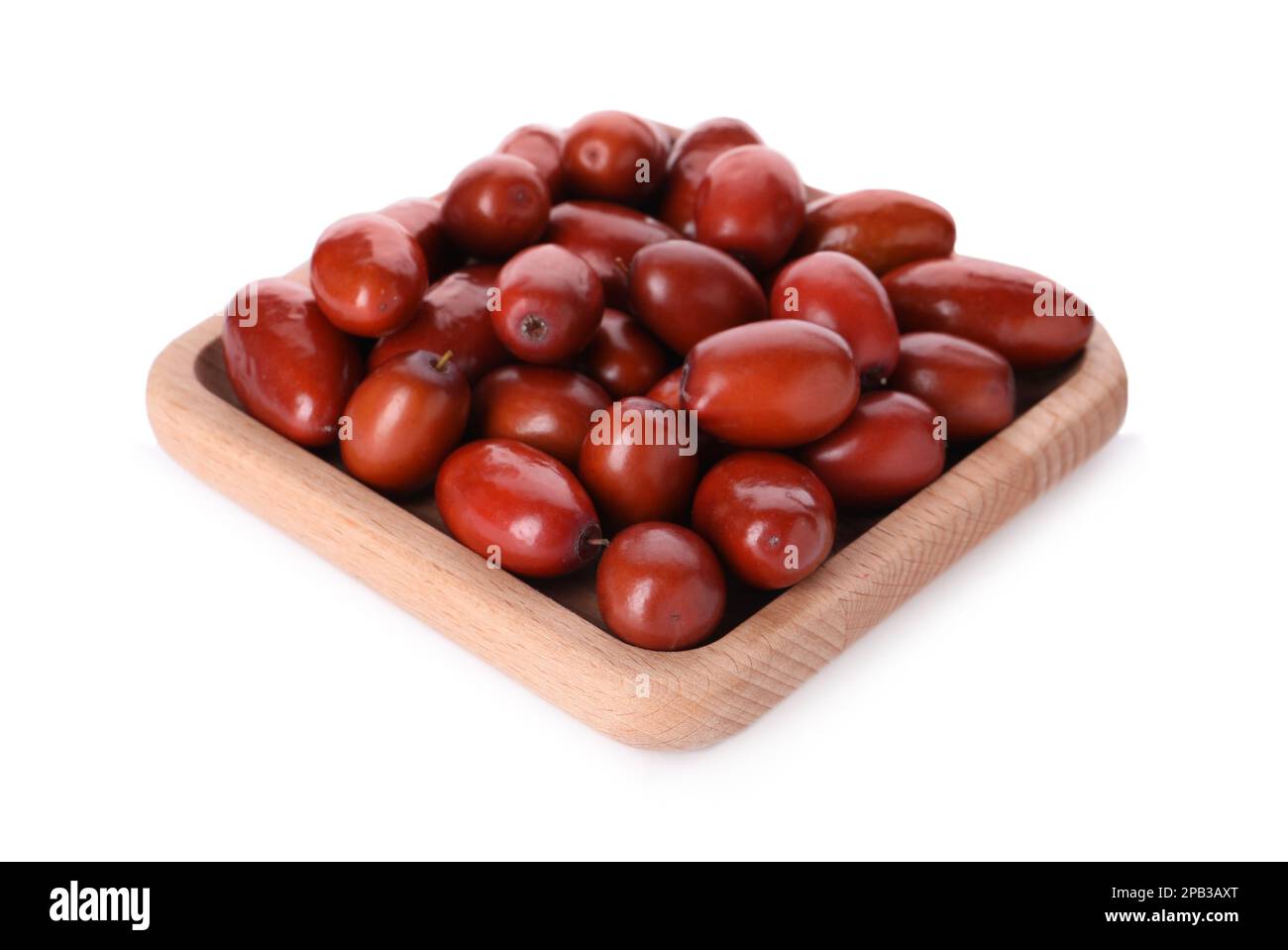 Wooden plate of ripe red dates on white background Stock Photo - Alamy
