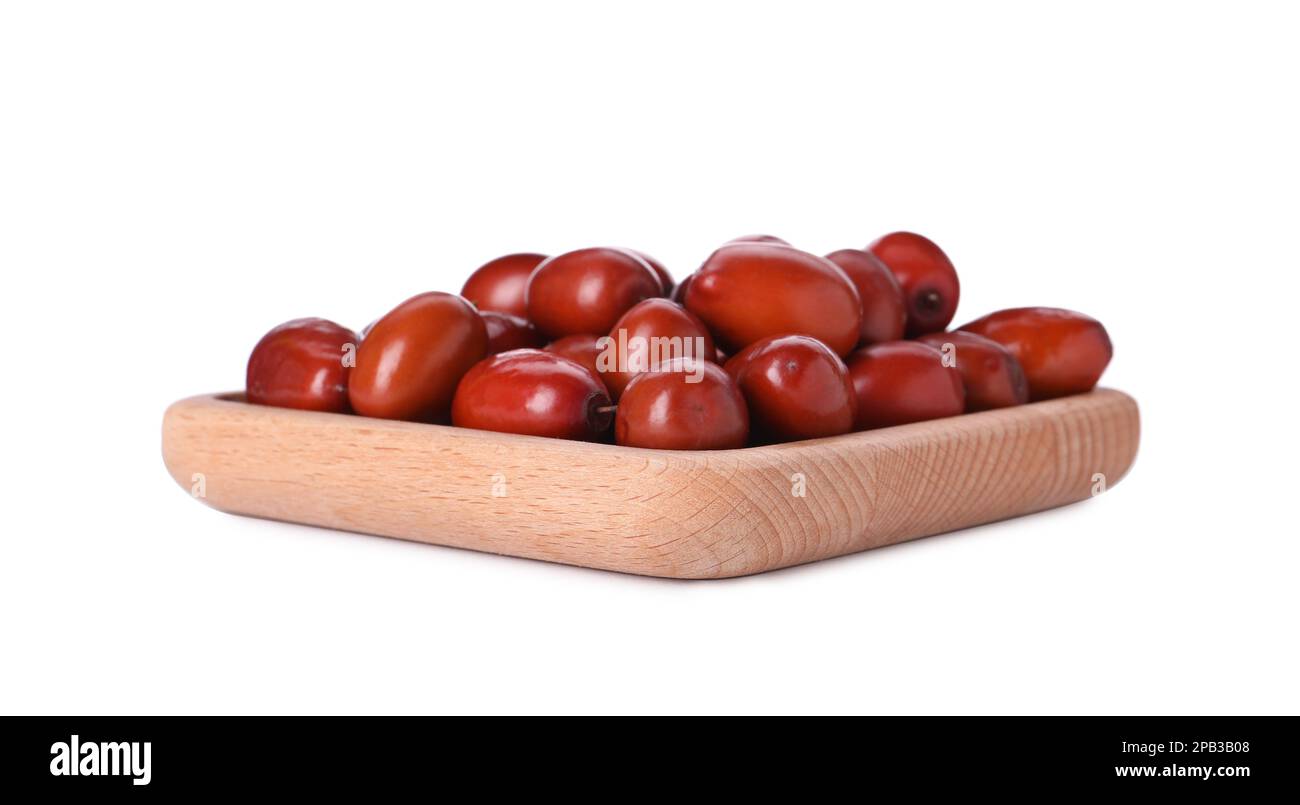 Wooden plate of ripe red dates on white background Stock Photo - Alamy
