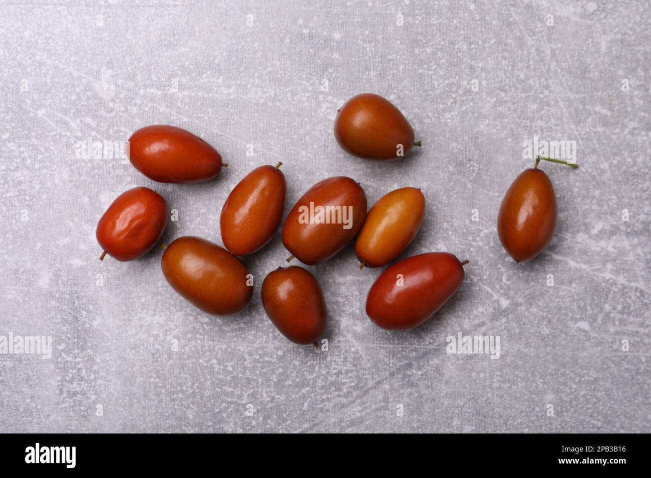 Fresh Ziziphus jujuba fruits on light table, flat lay Stock Photo - Alamy