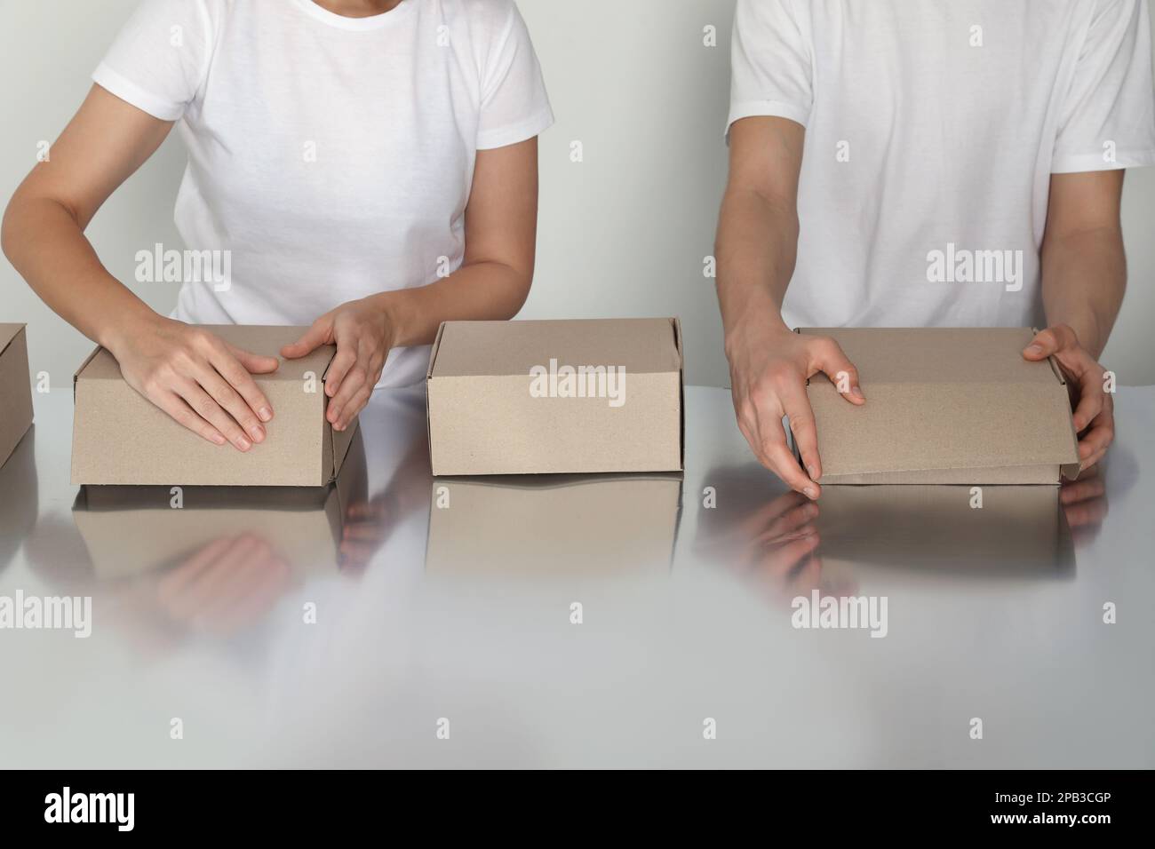 Woman folding cardboard boxes hi-res stock photography and images - Alamy