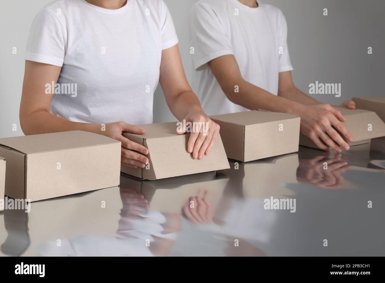 Woman folding cardboard boxes hi-res stock photography and images - Alamy