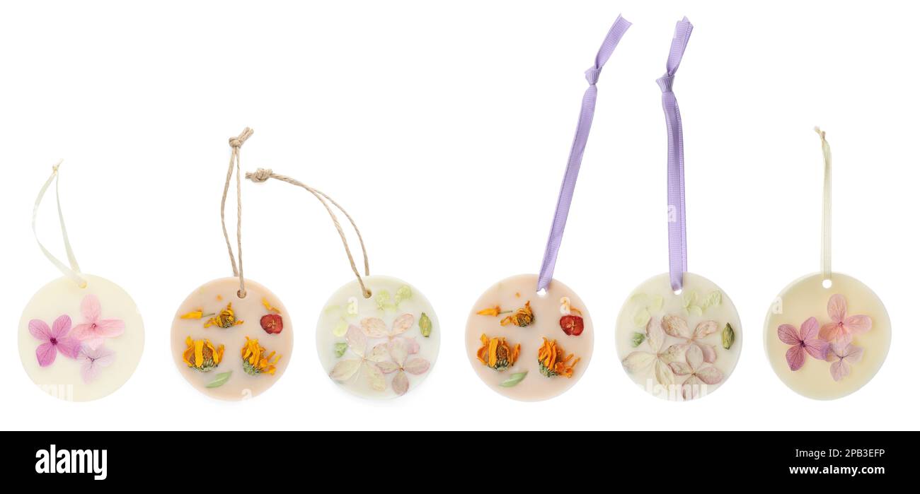 Beautiful scented sachets with dried flowers on white background ...