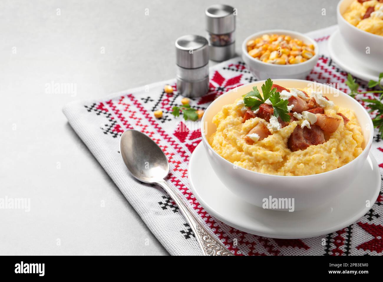 Delicious traditional Ukrainian banosh served on light table, space for ...