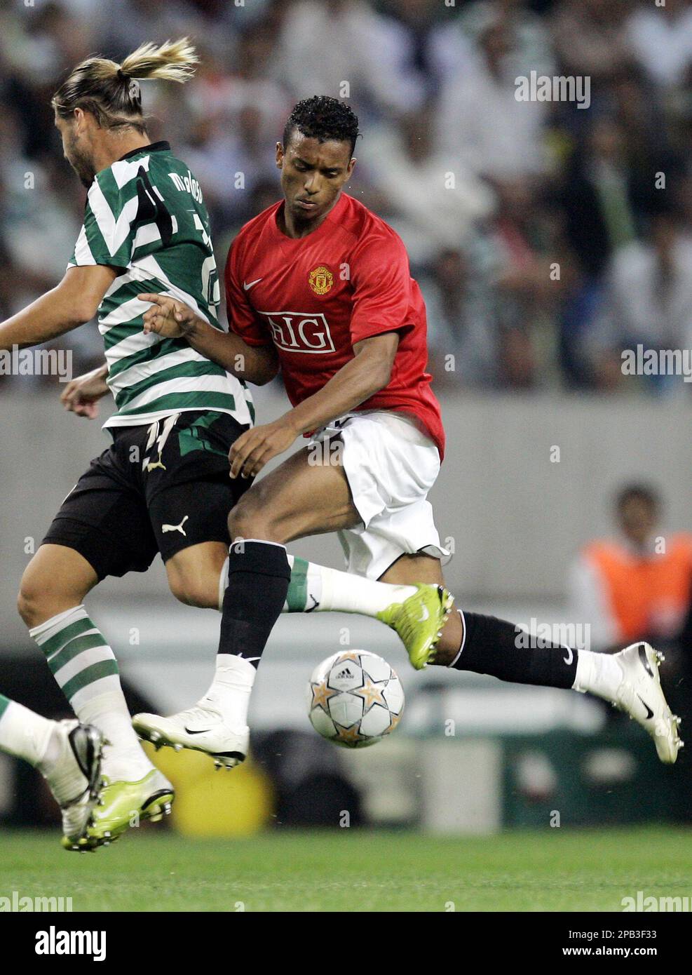 Manchester United's Portuguese player Nani, right, controls the ball ...