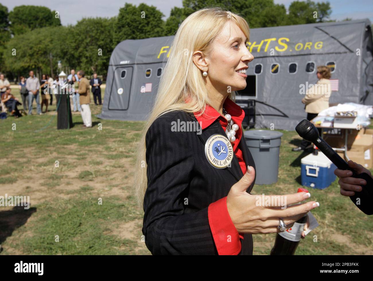 With a mock-up of an airplane cabin at rear, Kate Hanni, founder of the ...