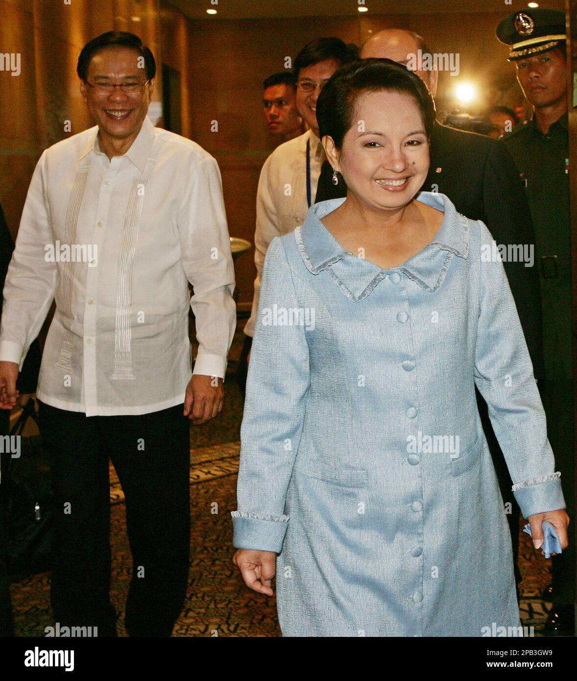 Philippine President Gloria Macapagal Arroyo, followed by former ...