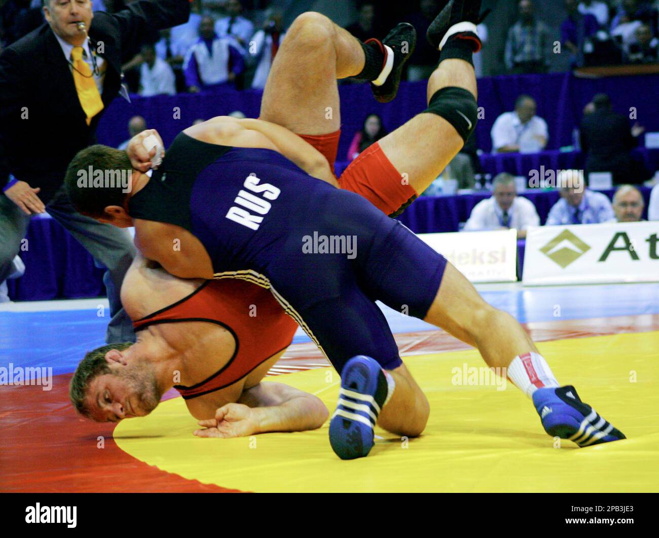 Russia's Alexey Mishin, foreground, wrestles with United States' Brad ...