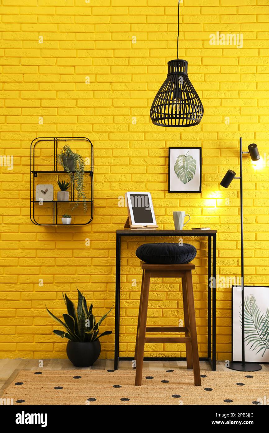 High wooden table with tablet and stool as stand up workplace near ...