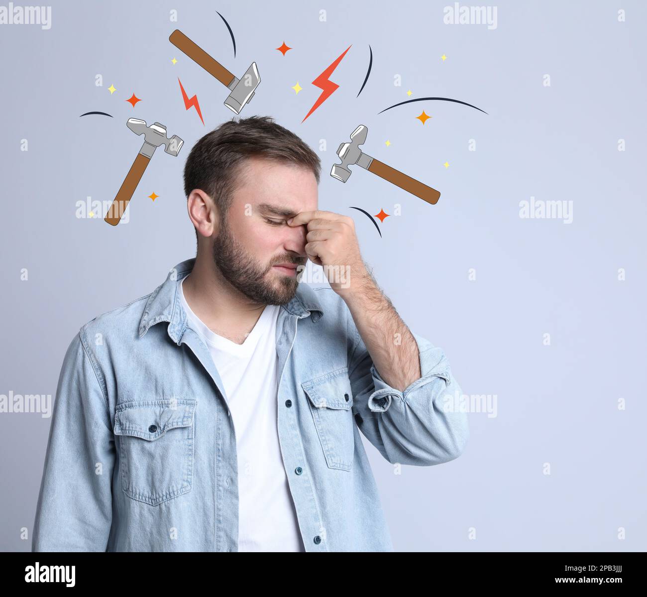 Young man having headache on light background. Illustration of hammers ...