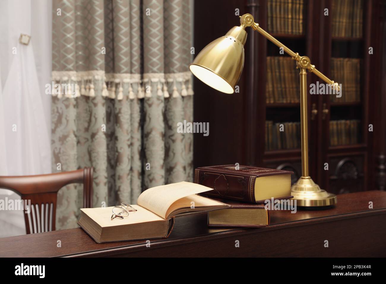 Books, glasses and lamp on wooden table in library reading room Stock ... Books, glasses and lamp on wooden table in library reading room Stock ...