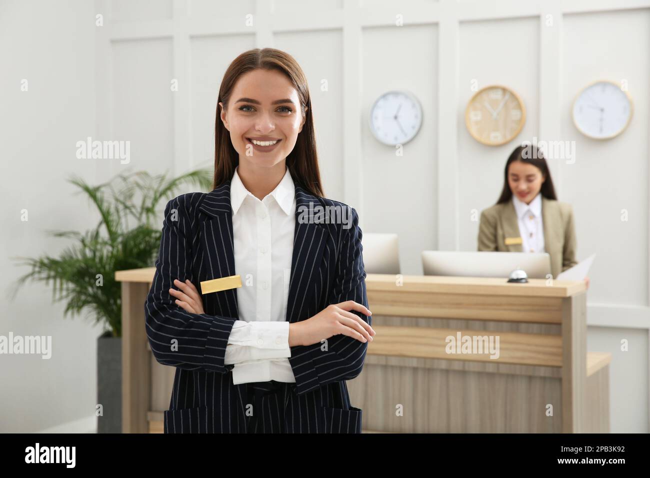 Portrait of beautiful receptionist near counter in hotel Stock Photo ...