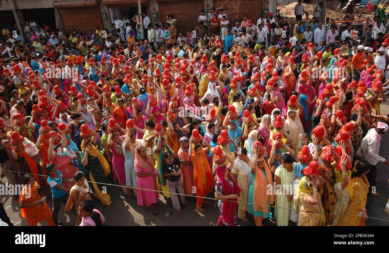 Women of Sindhi community carry earthen pots on their heads during a ...