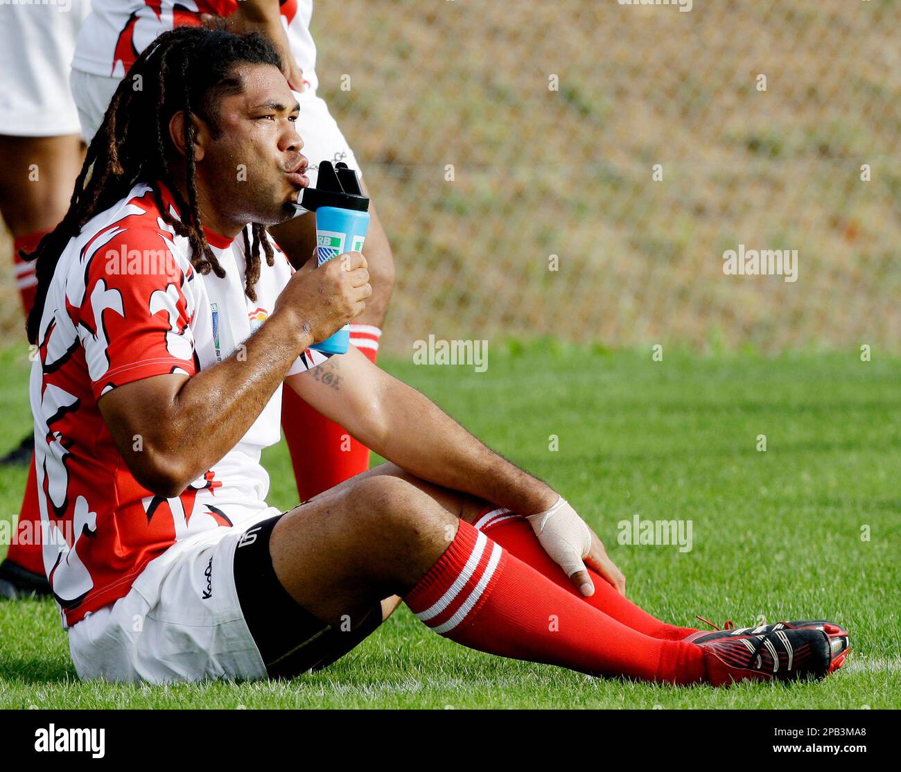 Tonga's Paino Hehea takes a drink during a team teaming session in ...