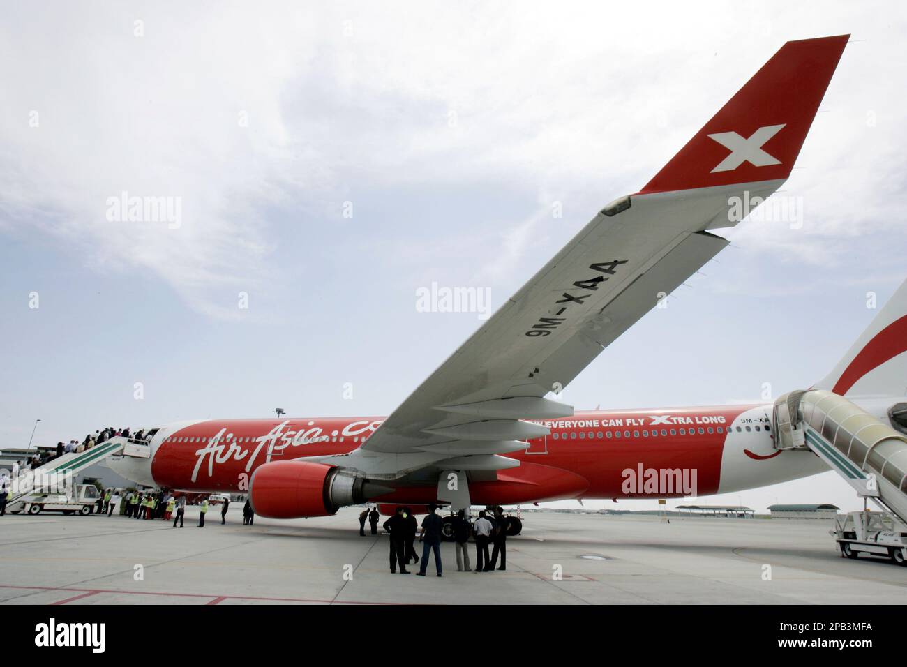 Visitors walk next to Air Asia X's new Airbus A330 aircraft during a ...