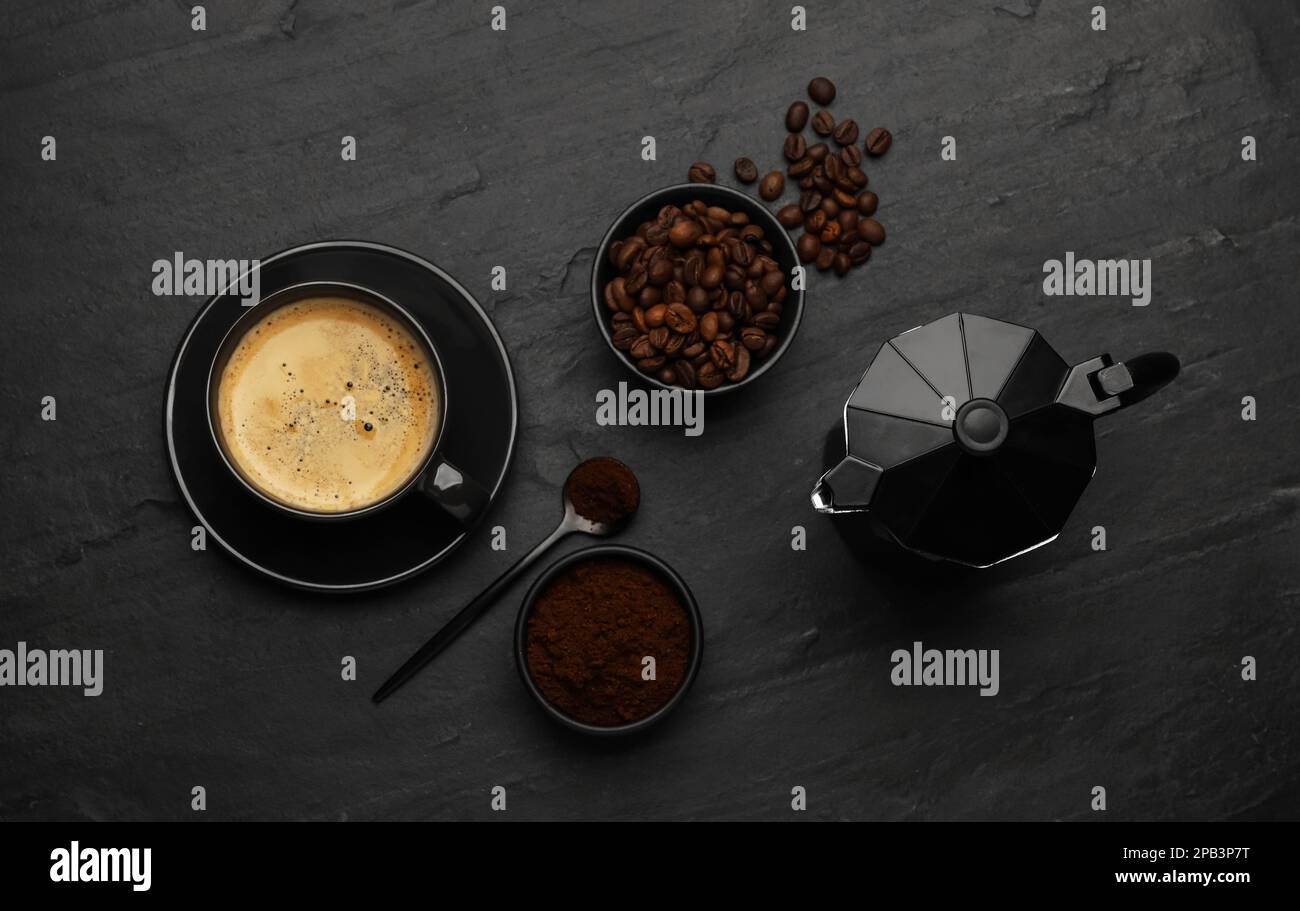 Flat lay composition with coffee grounds and roasted beans on black ...