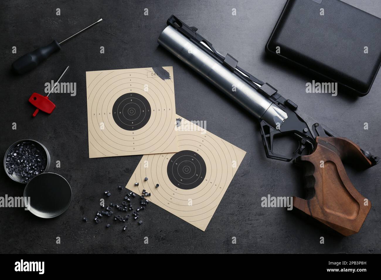 Flat lay composition with sport pistol on black table. Professional gun ...