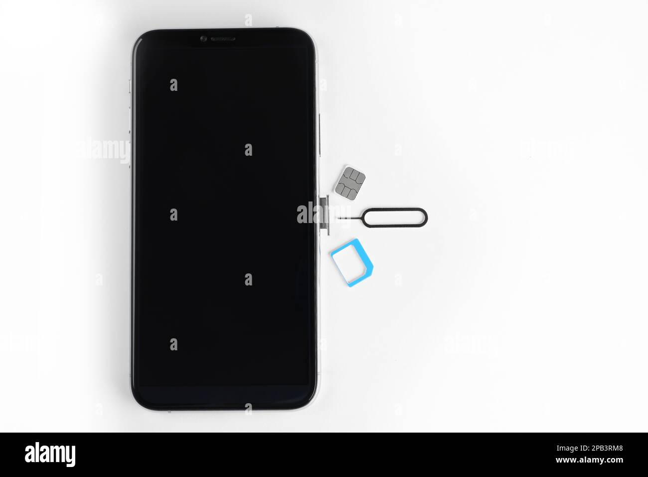 SIM card, mobile phone and ejector on white table, flat lay Stock Photo ...