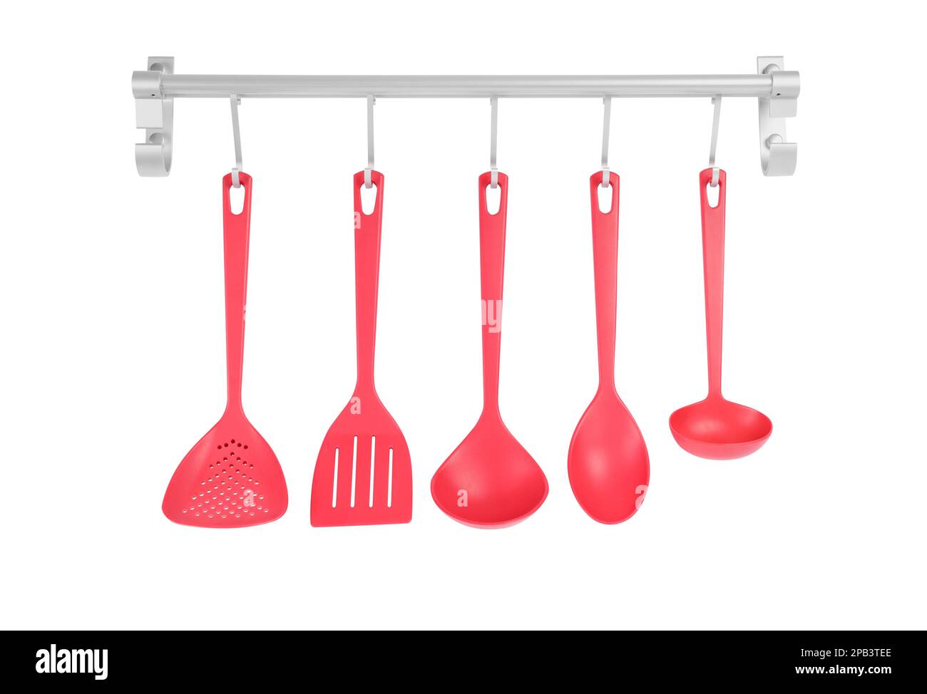 Metal rack with set of red kitchen utensils on white background Stock ...