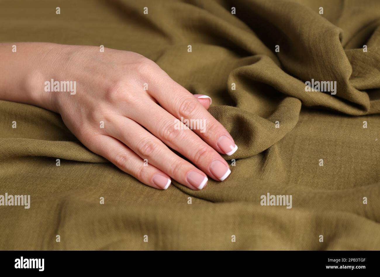 Woman touching soft linen fabric, closeup view Stock Photo - Alamy