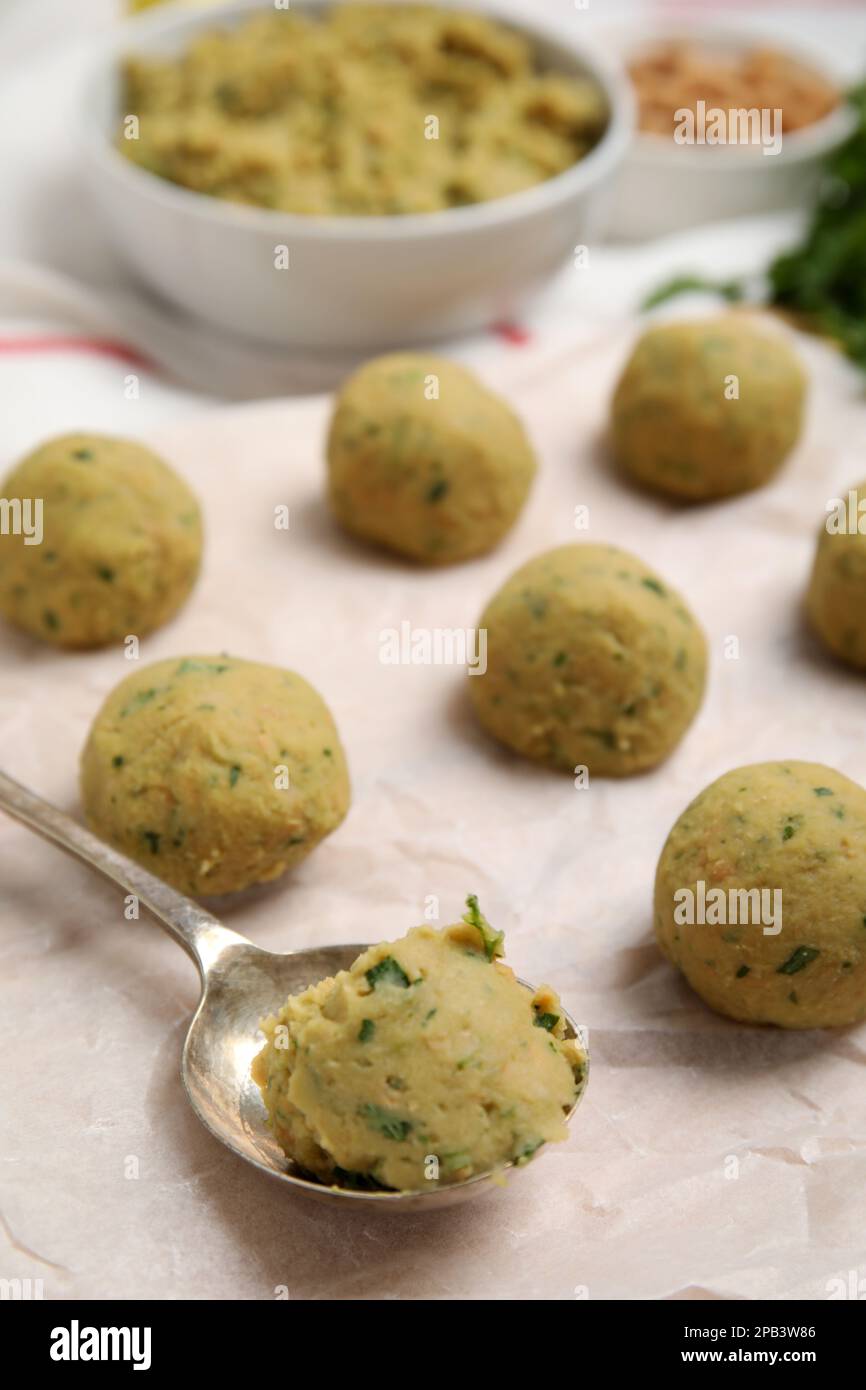 Raw falafel balls and spoon on parchment, closeup Stock Photo - Alamy