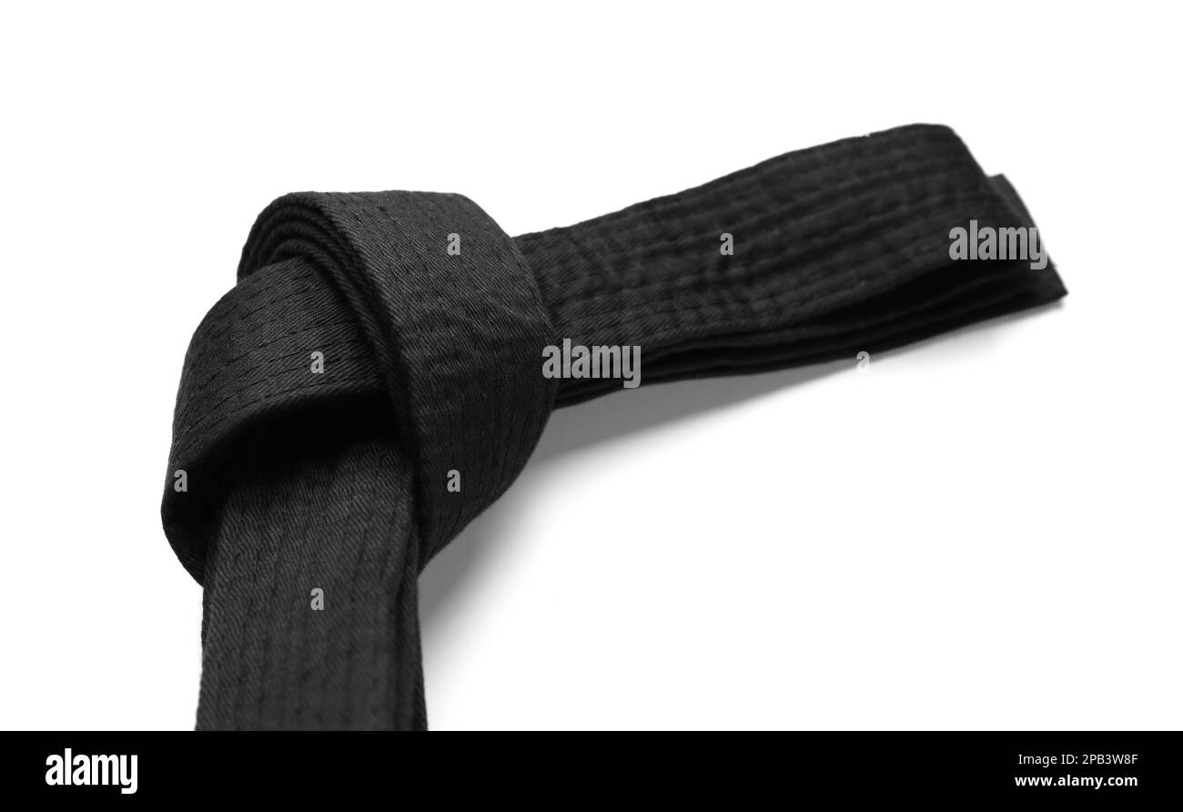 Tied black belt on white background, closeup. Oriental martial arts ...