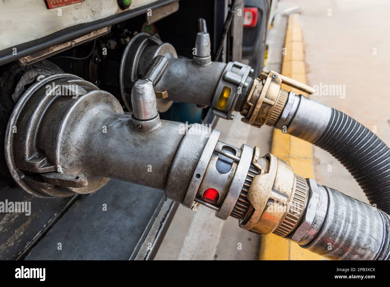 Devices attached to the mouths of a tanker truck to connect the ...