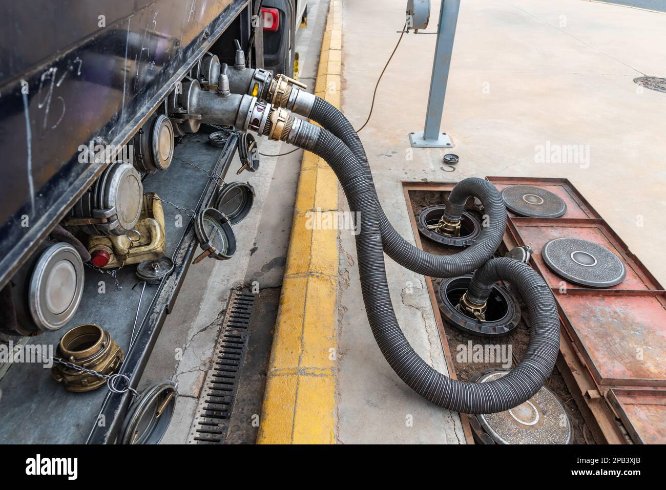 Fuel tanker truck unloading at a service station, unloading with two ...